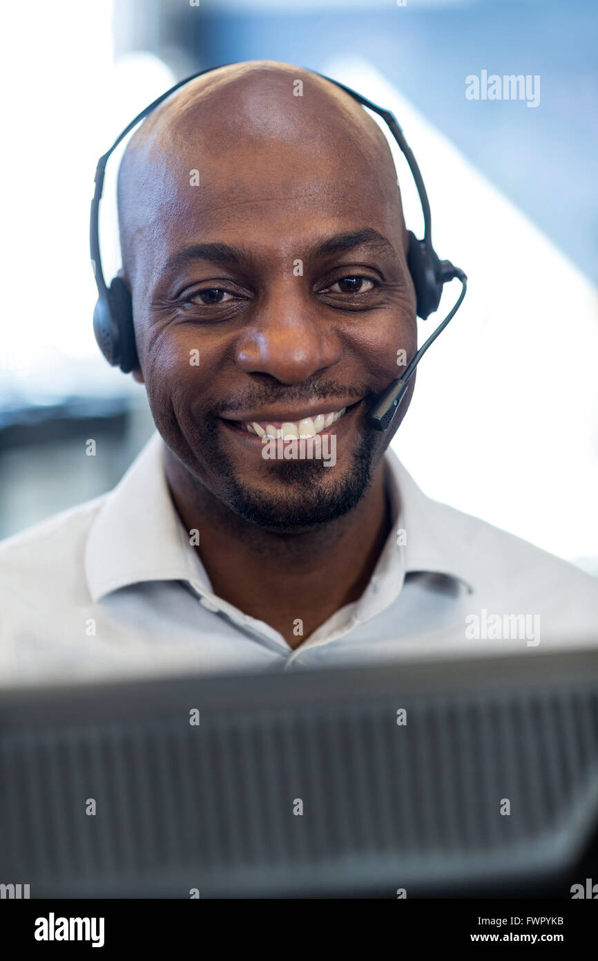 Man working on computer with headset Stock Photo - Alamy