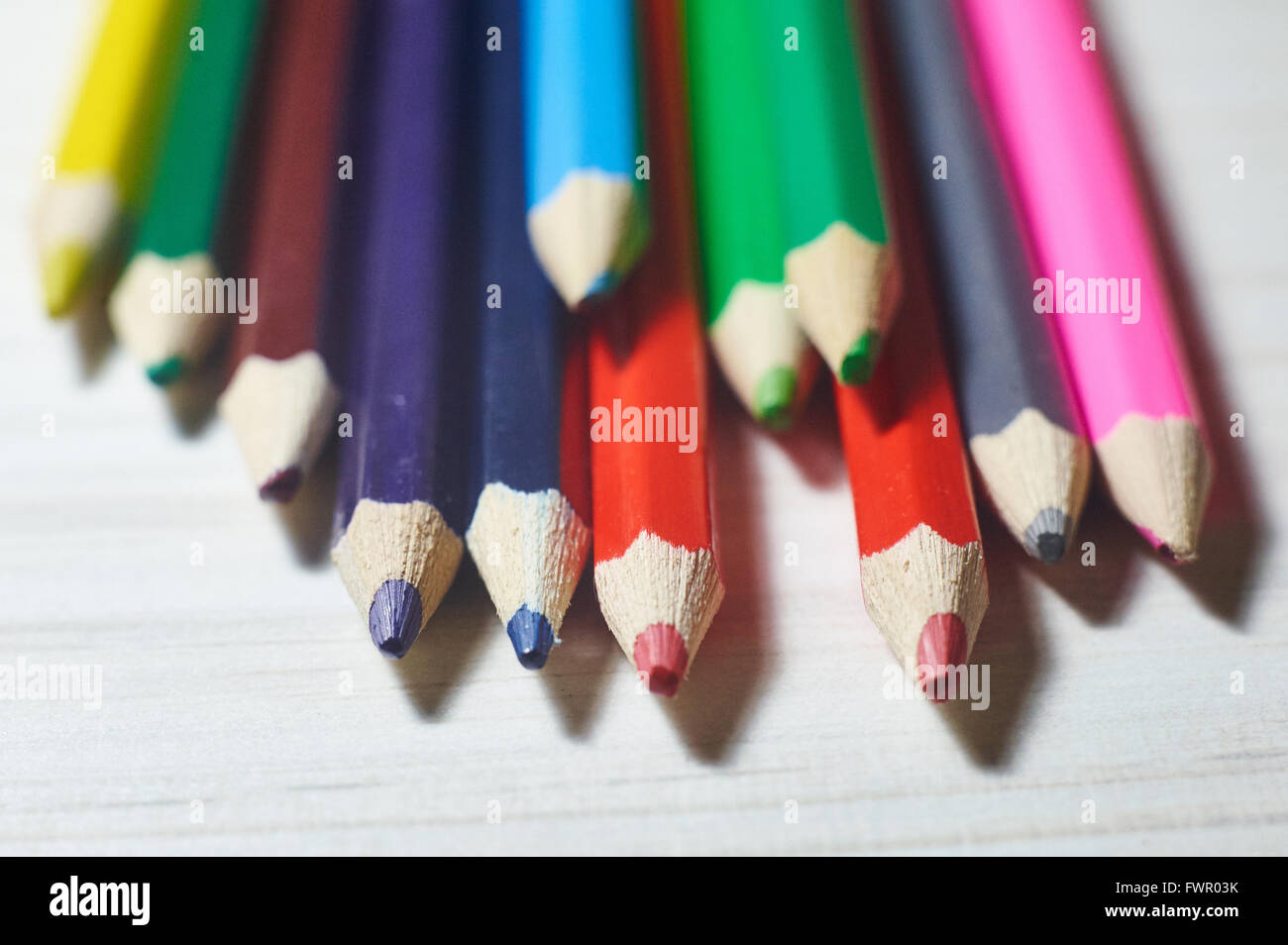 Stack of colored pencils on white table. Studio shot Stock Photo - Alamy
