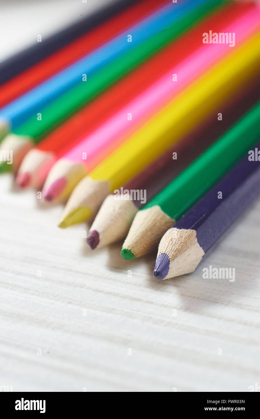 Stack of colored pencils on white table. Studio shot Stock Photo - Alamy