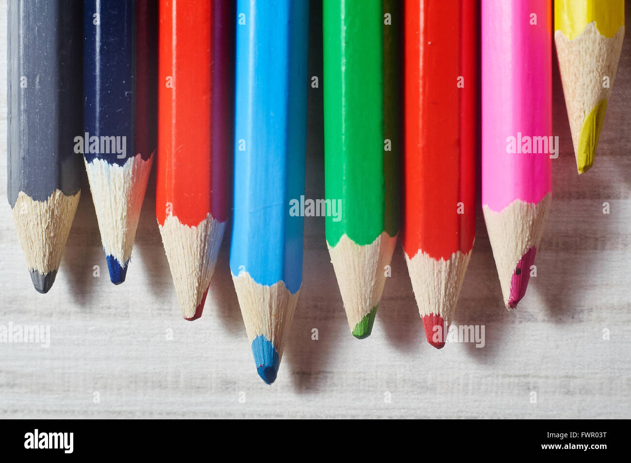Stack of colored pencils on white table. Studio shot Stock Photo - Alamy