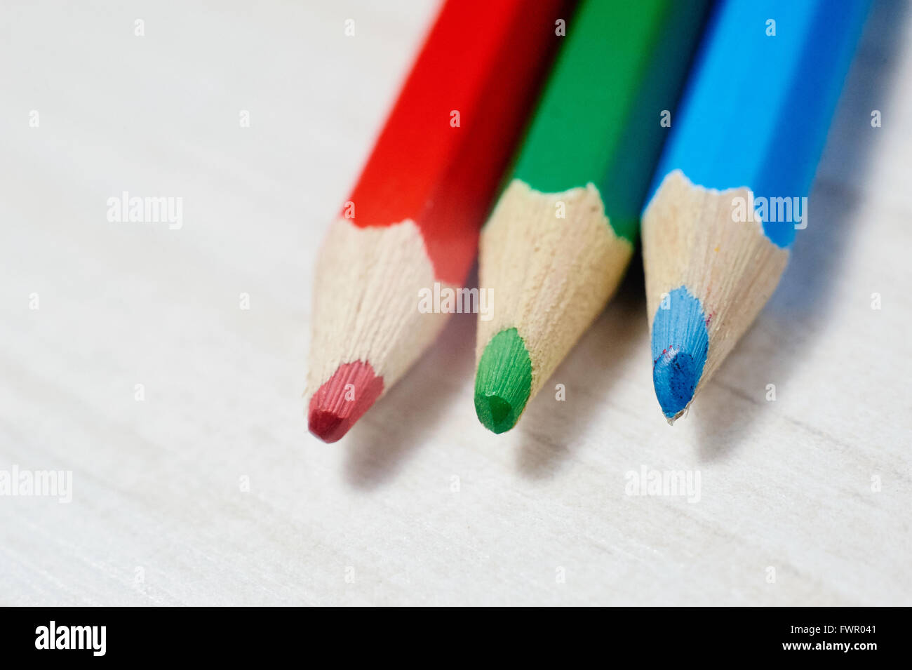 Stack of colored pencils on white table. Studio shot Stock Photo - Alamy