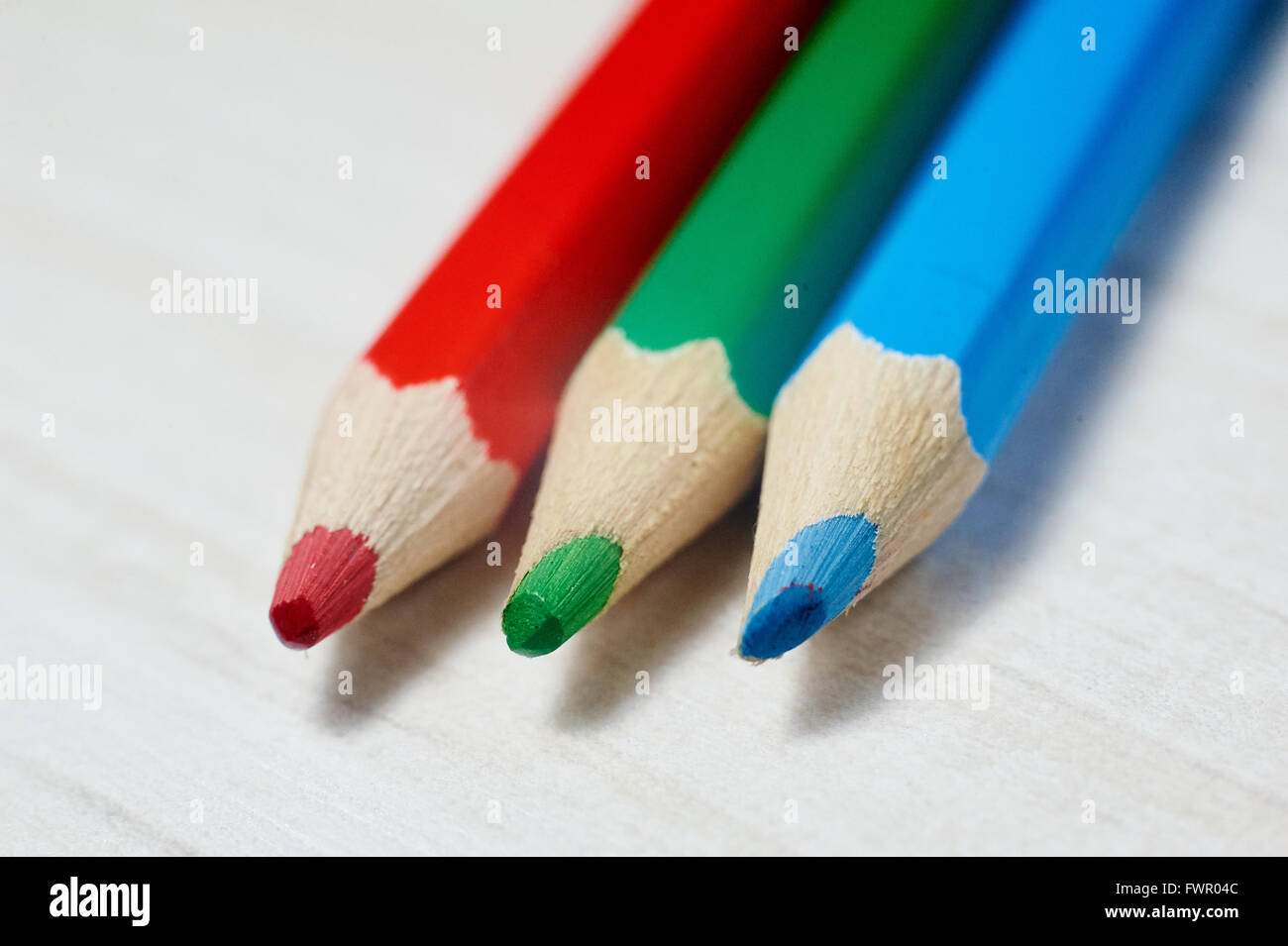 Stack of colored pencils on white table. Studio shot Stock Photo - Alamy
