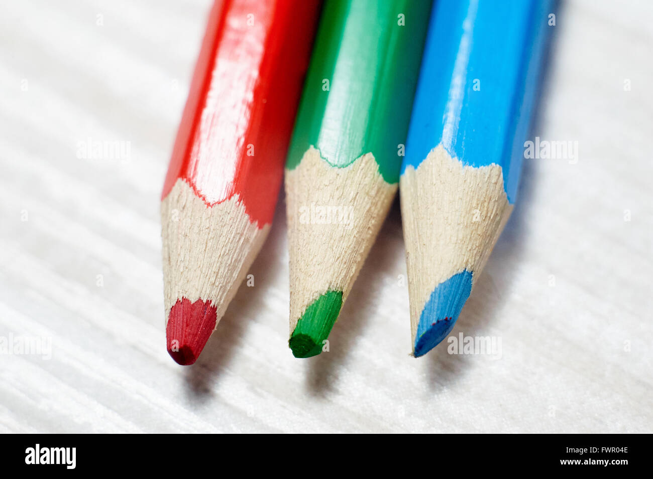Stack of colored pencils on white table. Studio shot Stock Photo - Alamy