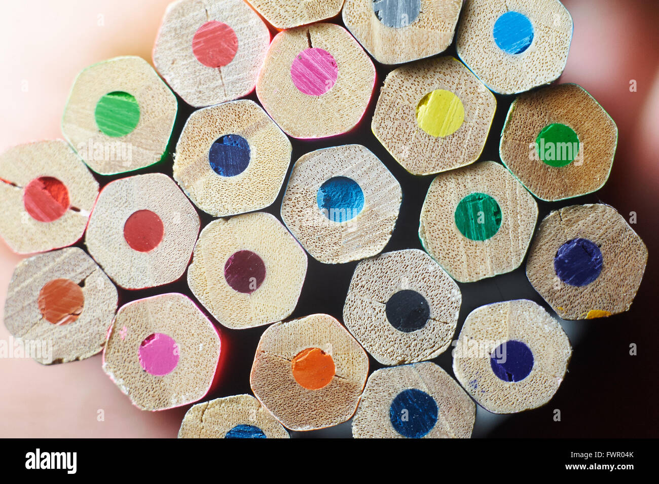 Stack of colored pencils on white table. Studio shot Stock Photo - Alamy