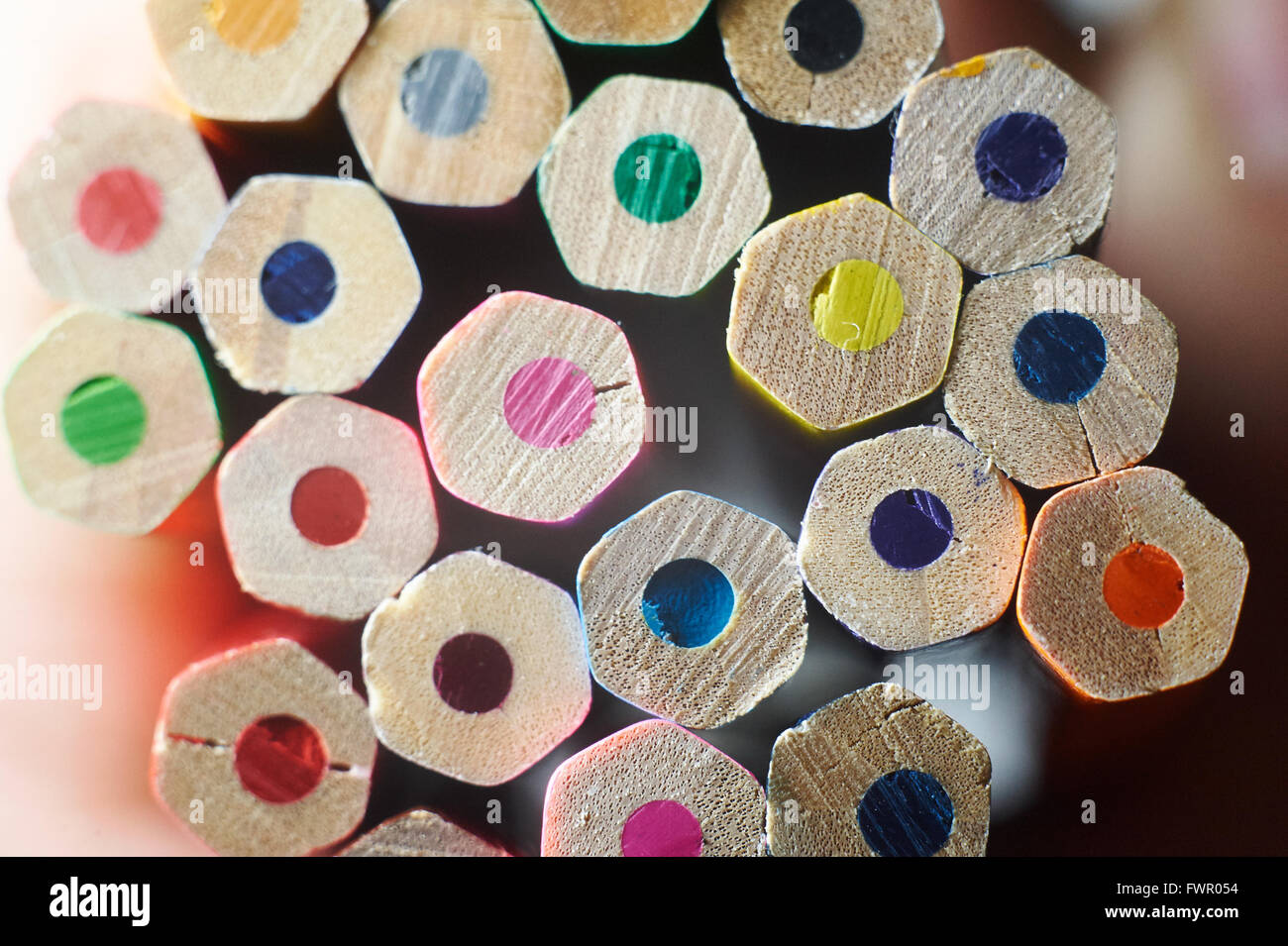 Stack of colored pencils on white table. Studio shot Stock Photo - Alamy