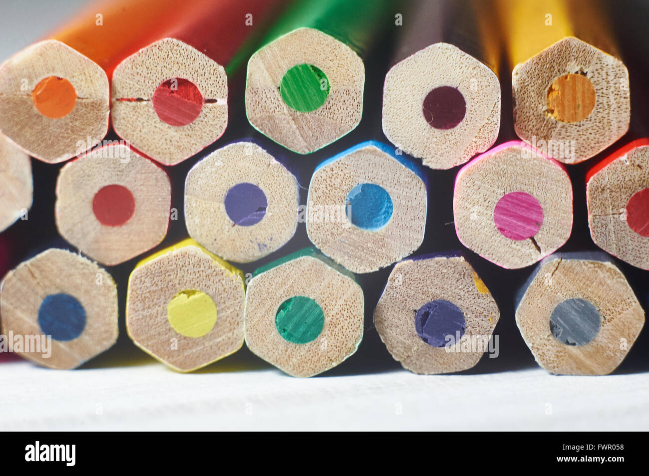 Stack of colored pencils on white table. Studio shot Stock Photo - Alamy