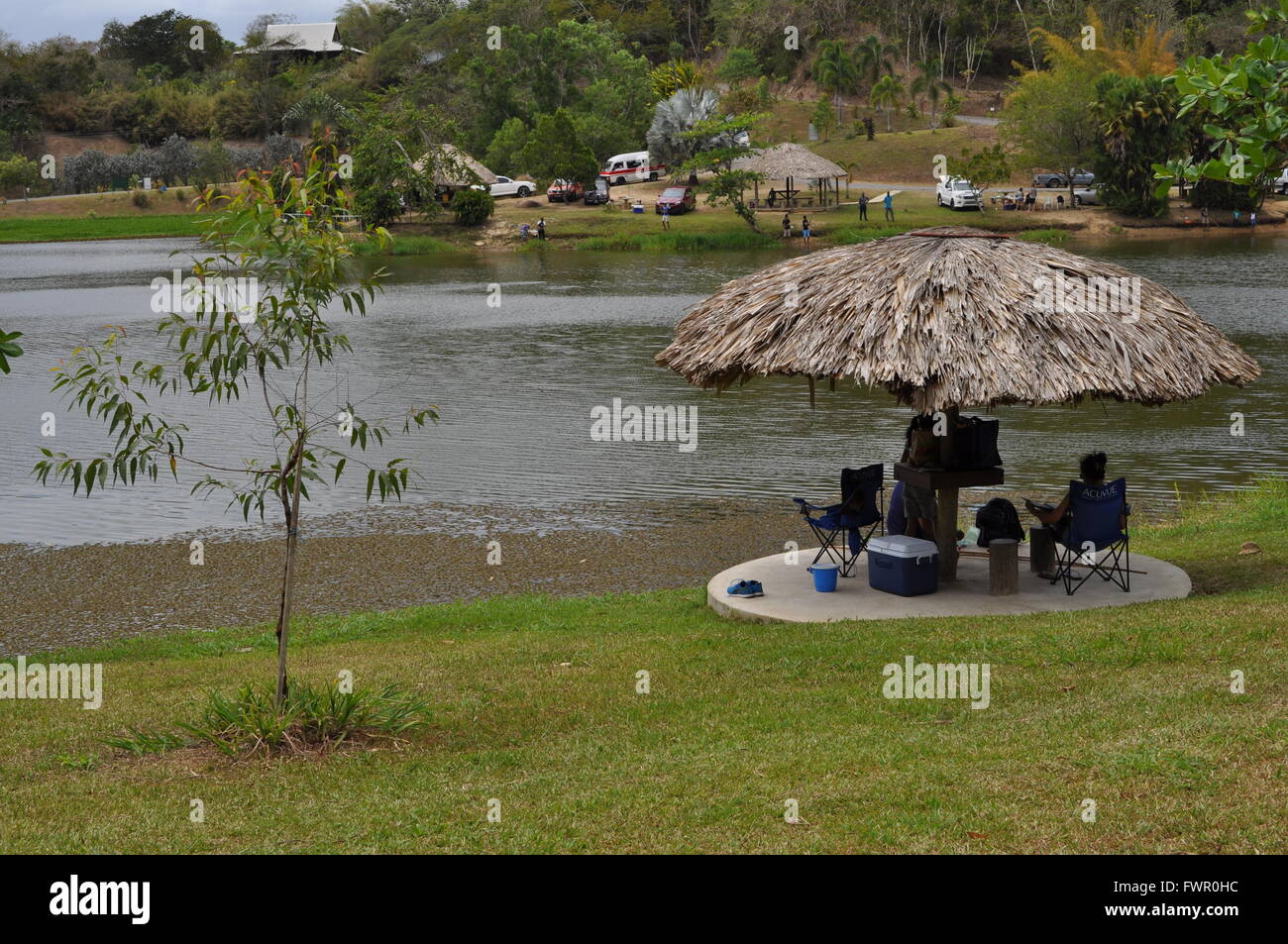 Family relaxing in a hut near a lake Stock Photo - Alamy