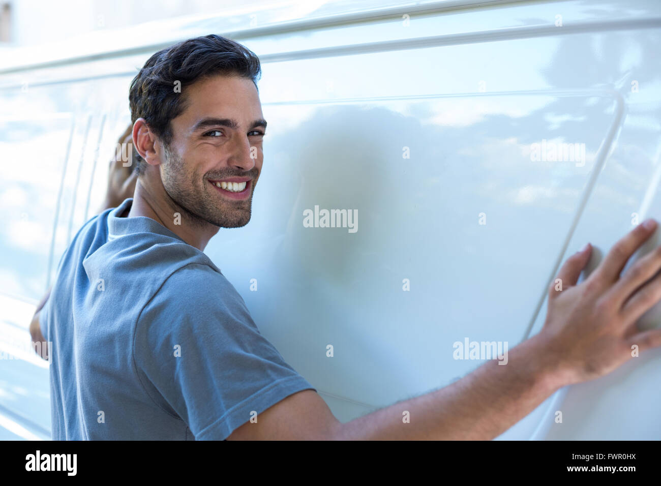 handsome man hugging car Stock Photo - Alamy