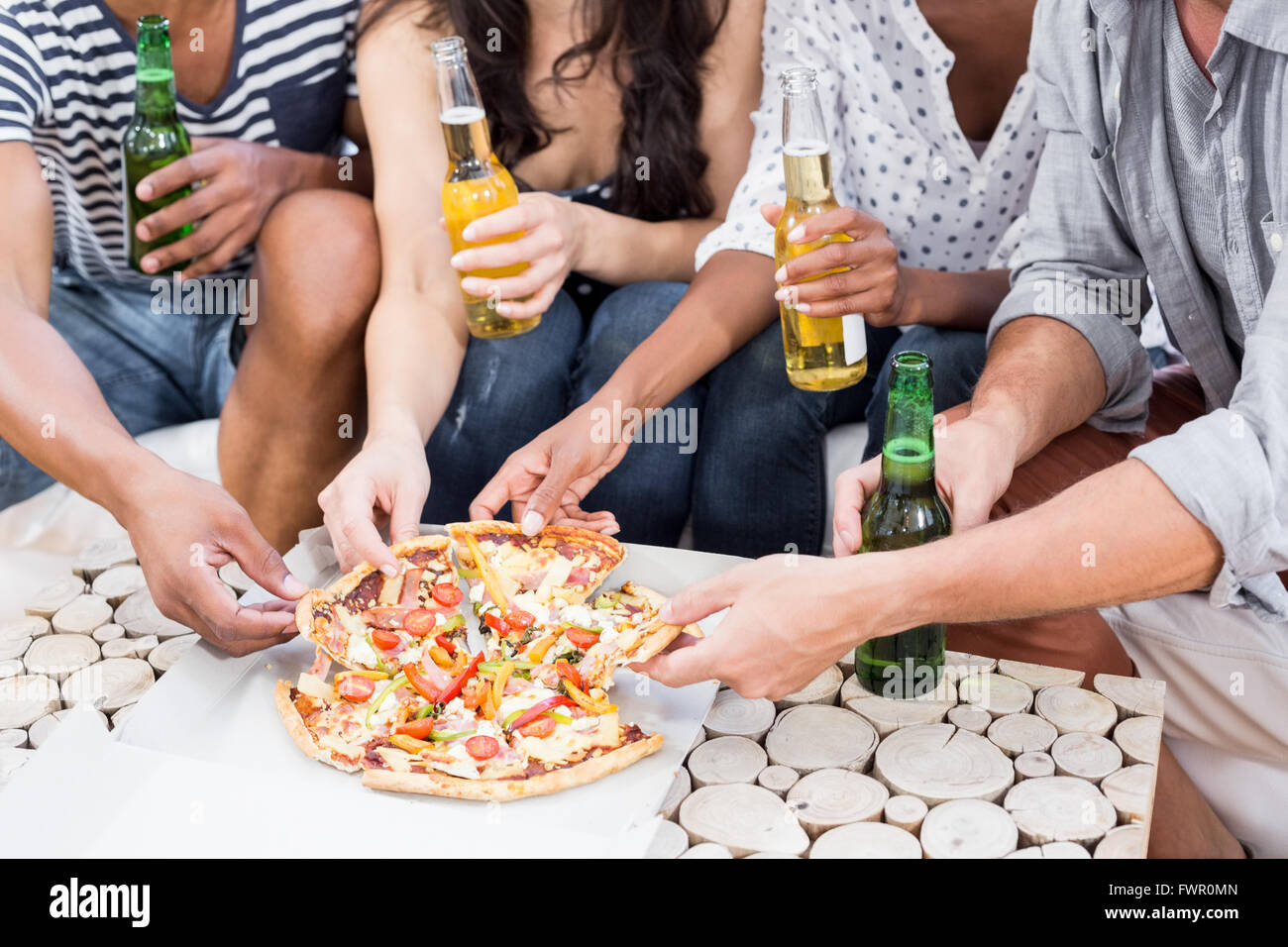 Friends having a pizza Stock Photo - Alamy