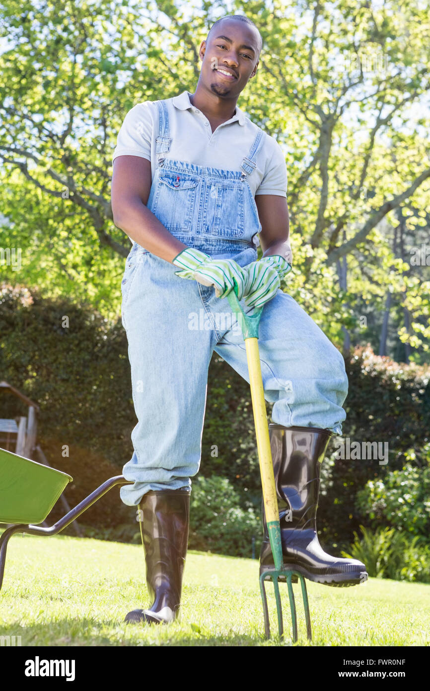 Young man posing with rake Stock Photo - Alamy