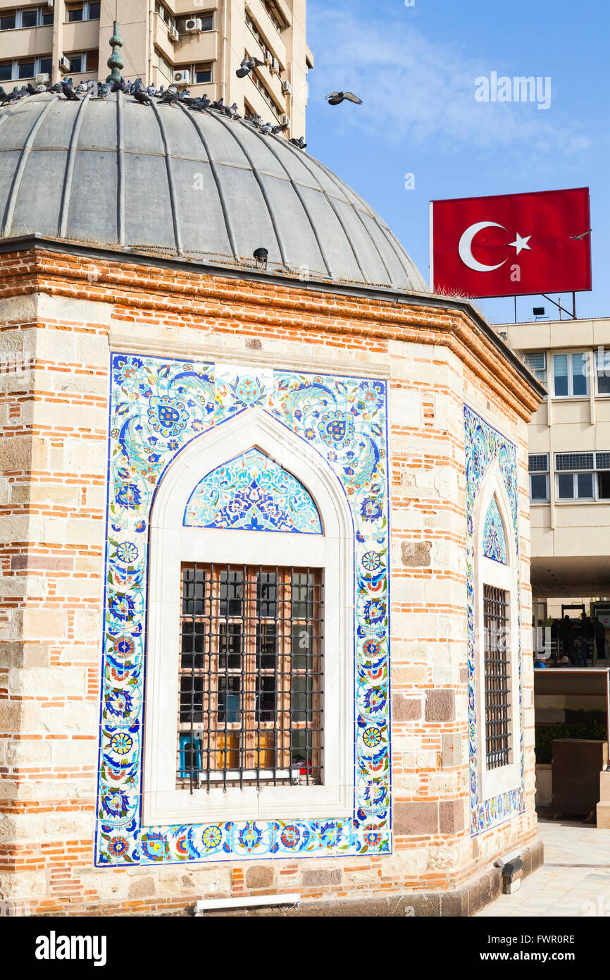 Facade of ancient Camii mosque and Turkish flag banner on the wall ...