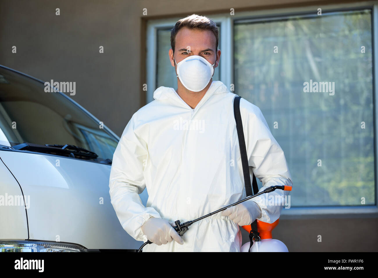 Portrait of pest control man standing next to a van Stock Photo - Alamy