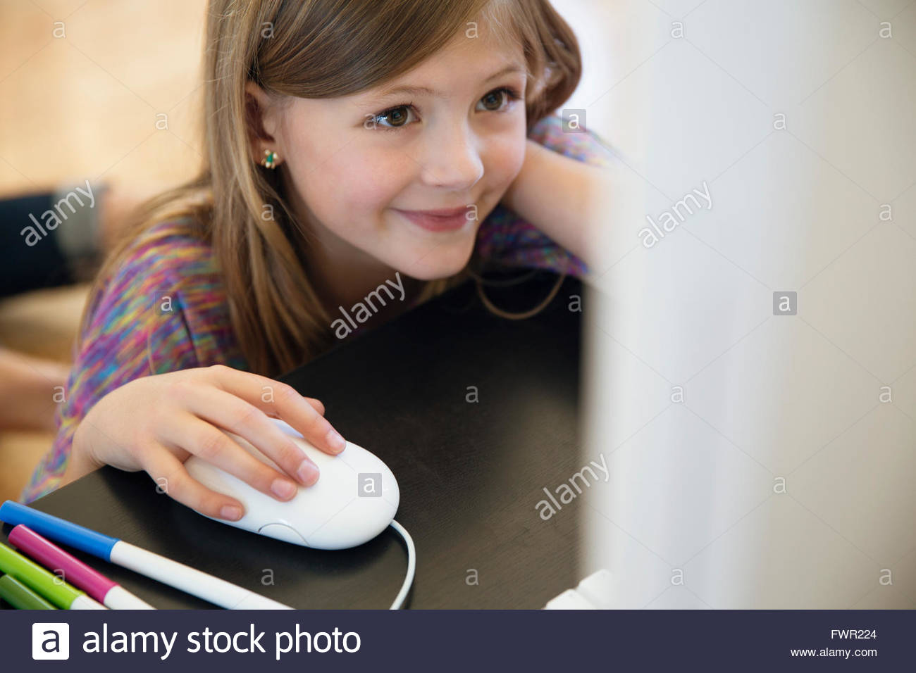 Little girl using computer hi-res stock photography and images - Alamy
