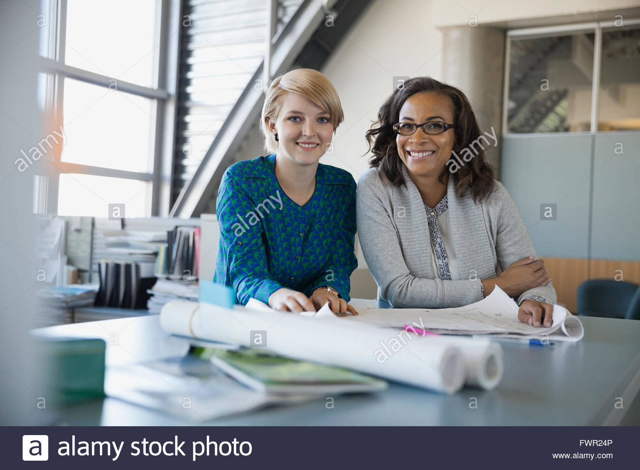 Portrait of businesswomen with blueprints Stock Photo - Alamy