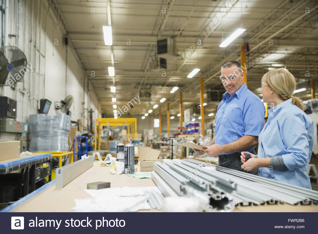 Manual workers in metal factory Stock Photo - Alamy