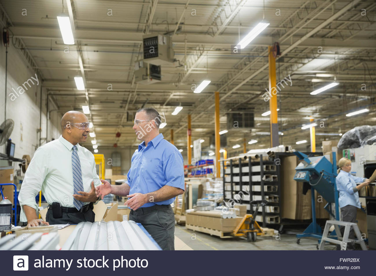 Manager and worker in metal fabrication warehouse Stock Photo - Alamy