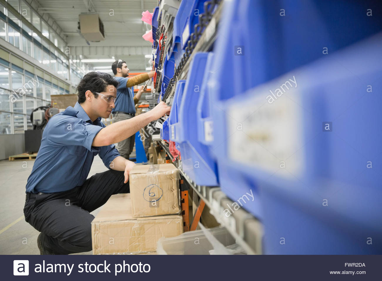 Worker picking parts in warehouse Stock Photo - Alamy