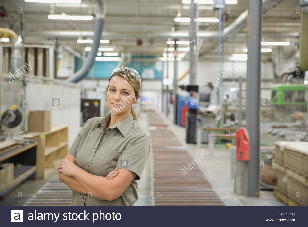 Portrait of confident worker in warehouse Stock Photo - Alamy