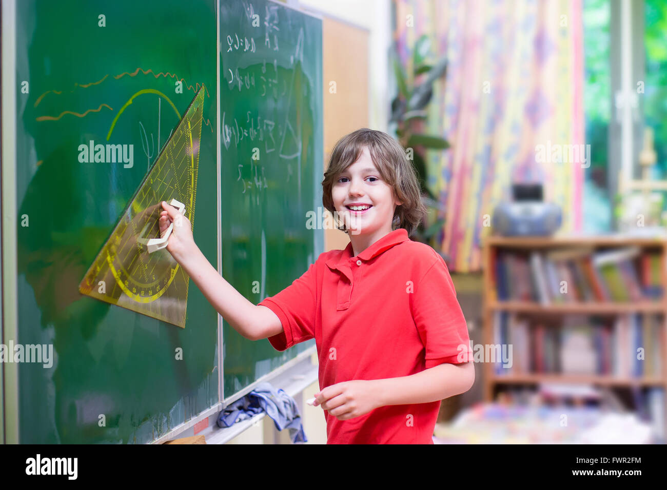 Happy smiling student boy enjoying his first day back to school at a ...