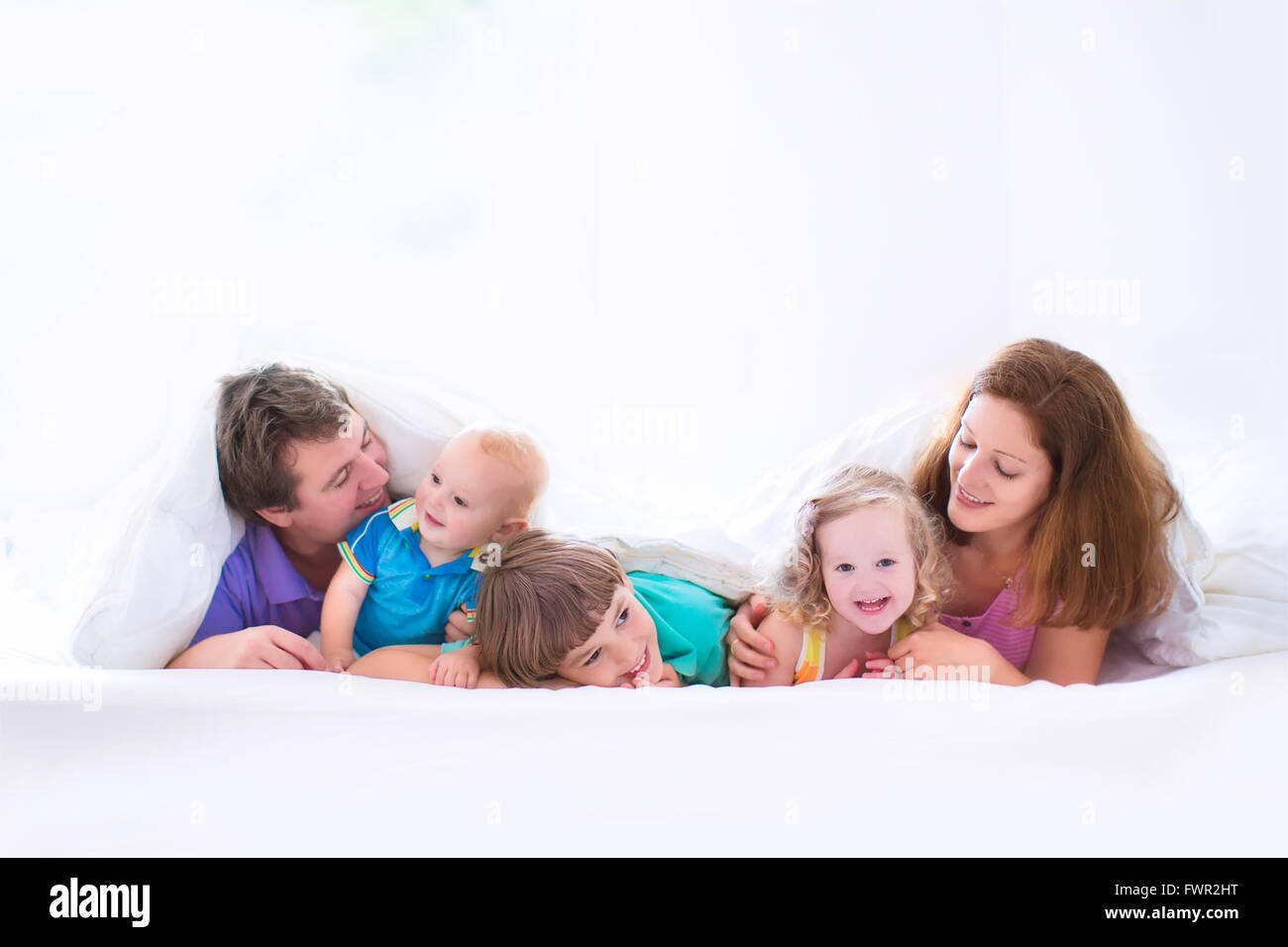 Happy big family, young parents with three kids, laughing boy, cute ...