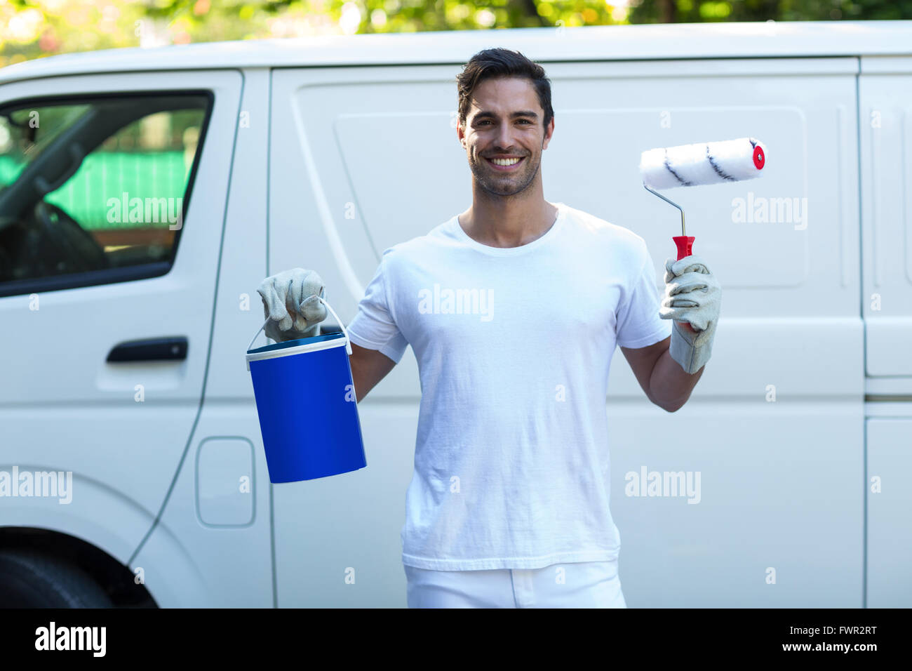 Portrait of happy painter against van Stock Photo - Alamy