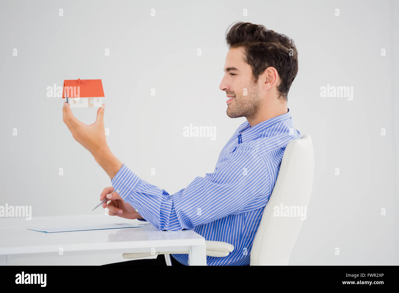 Businessman holding paper model house hi-res stock photography and ...