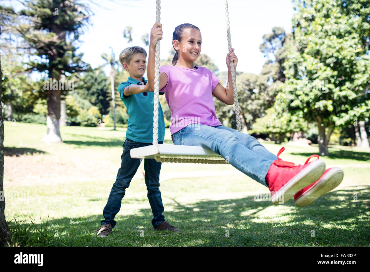 Brother sister on swing together hi-res stock photography and images ...