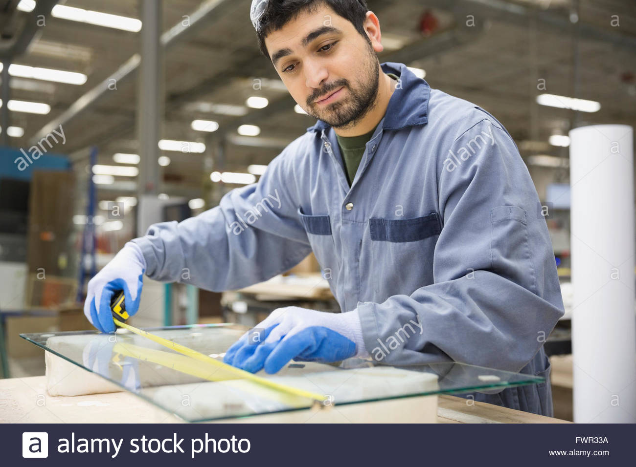Worker measuring manufacturing hi-res stock photography and images - Alamy