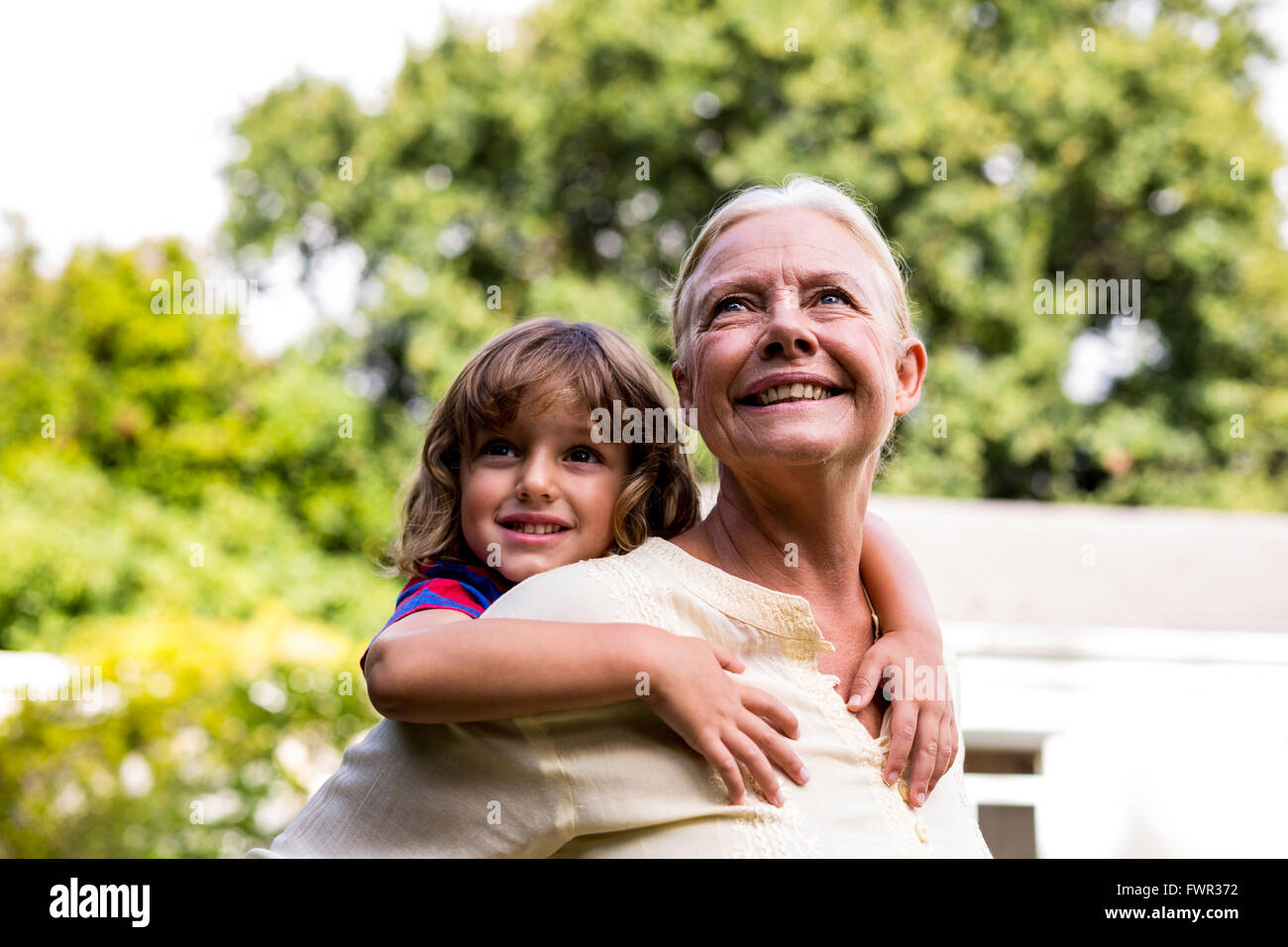 Grandmother carrying grandson at yard Stock Photo - Alamy