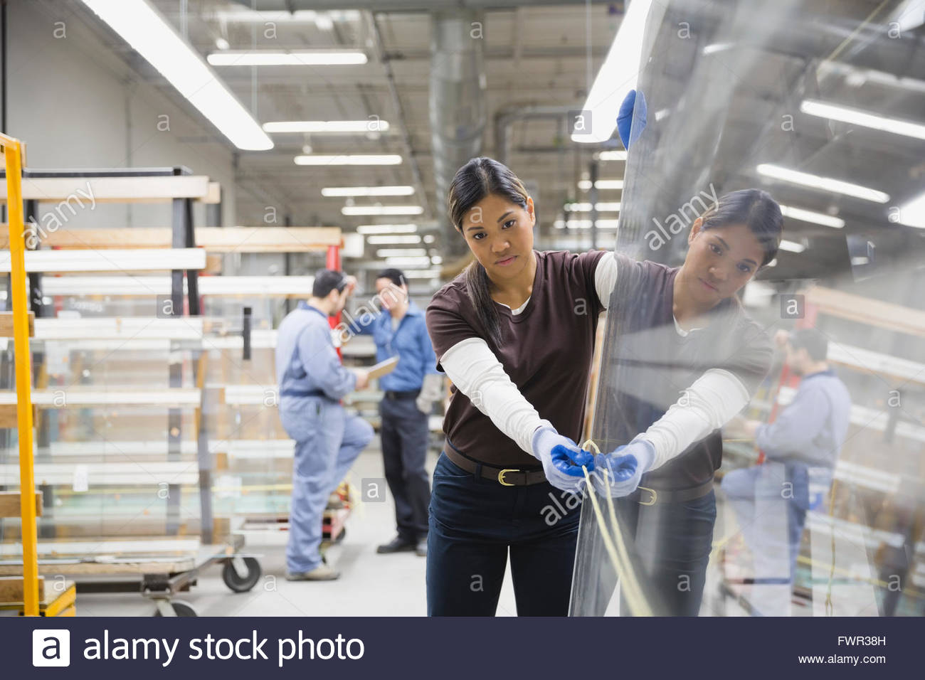 Worker packaging glass sheets in warehouse Stock Photo - Alamy