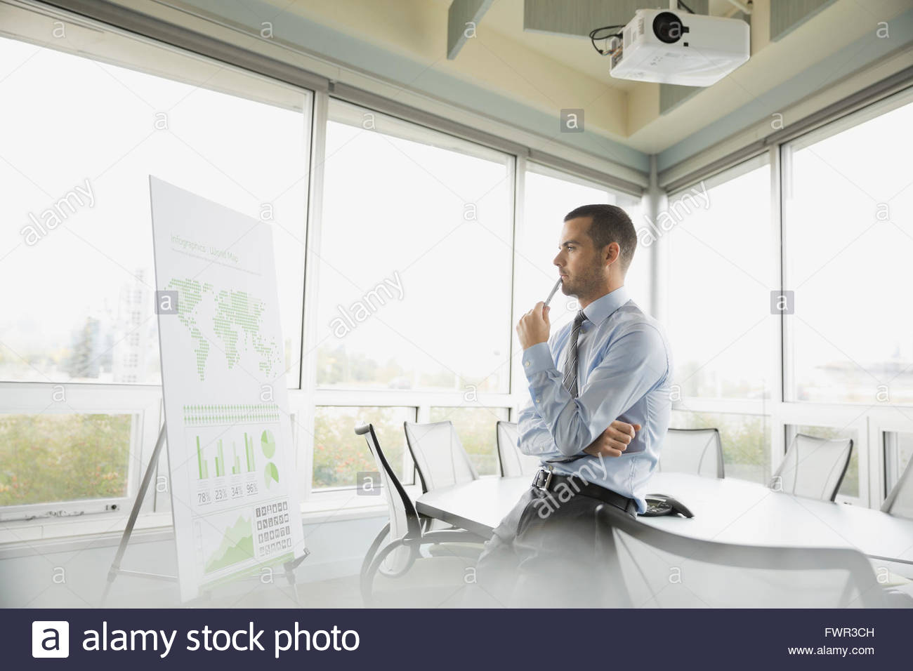 Businessman analyzing graph chart in boardroom Stock Photo - Alamy
