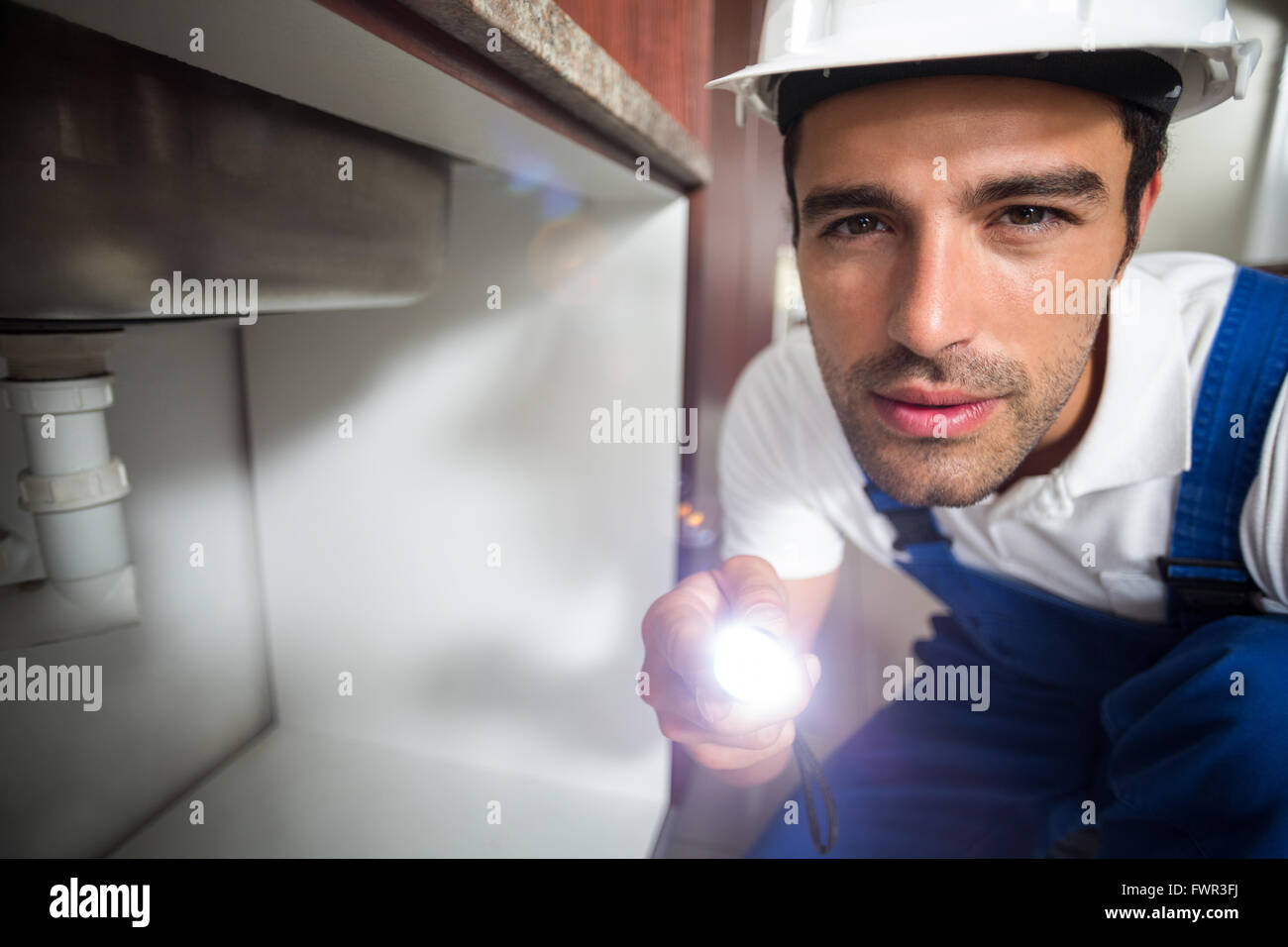 Portrait of man holding illuminated torch Stock Photo - Alamy