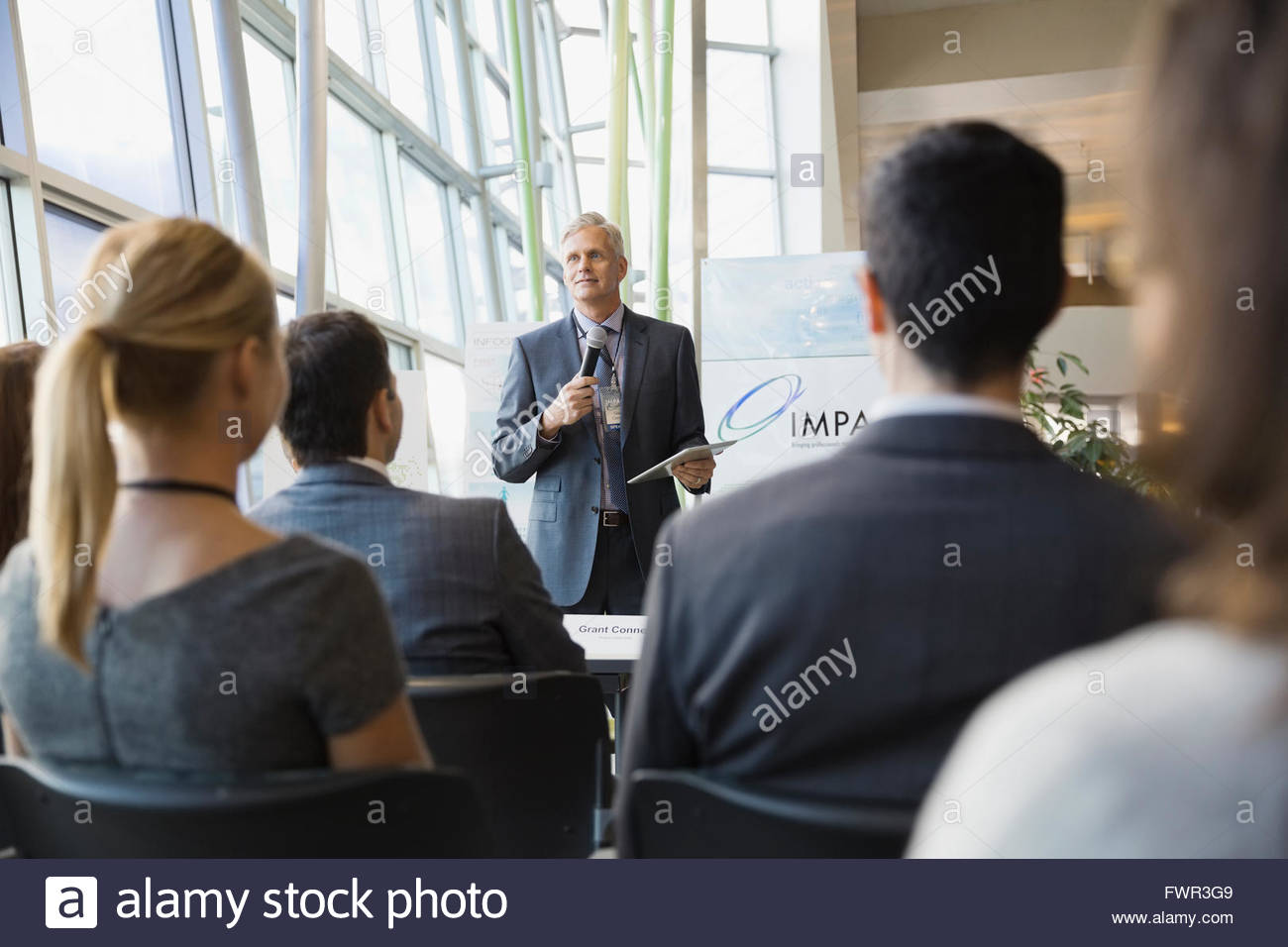 Standing looking away microphone communication hi-res stock photography ...