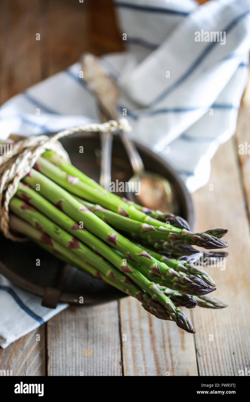 Bunch of fresh asparagus on wooden table Stock Photo - Alamy