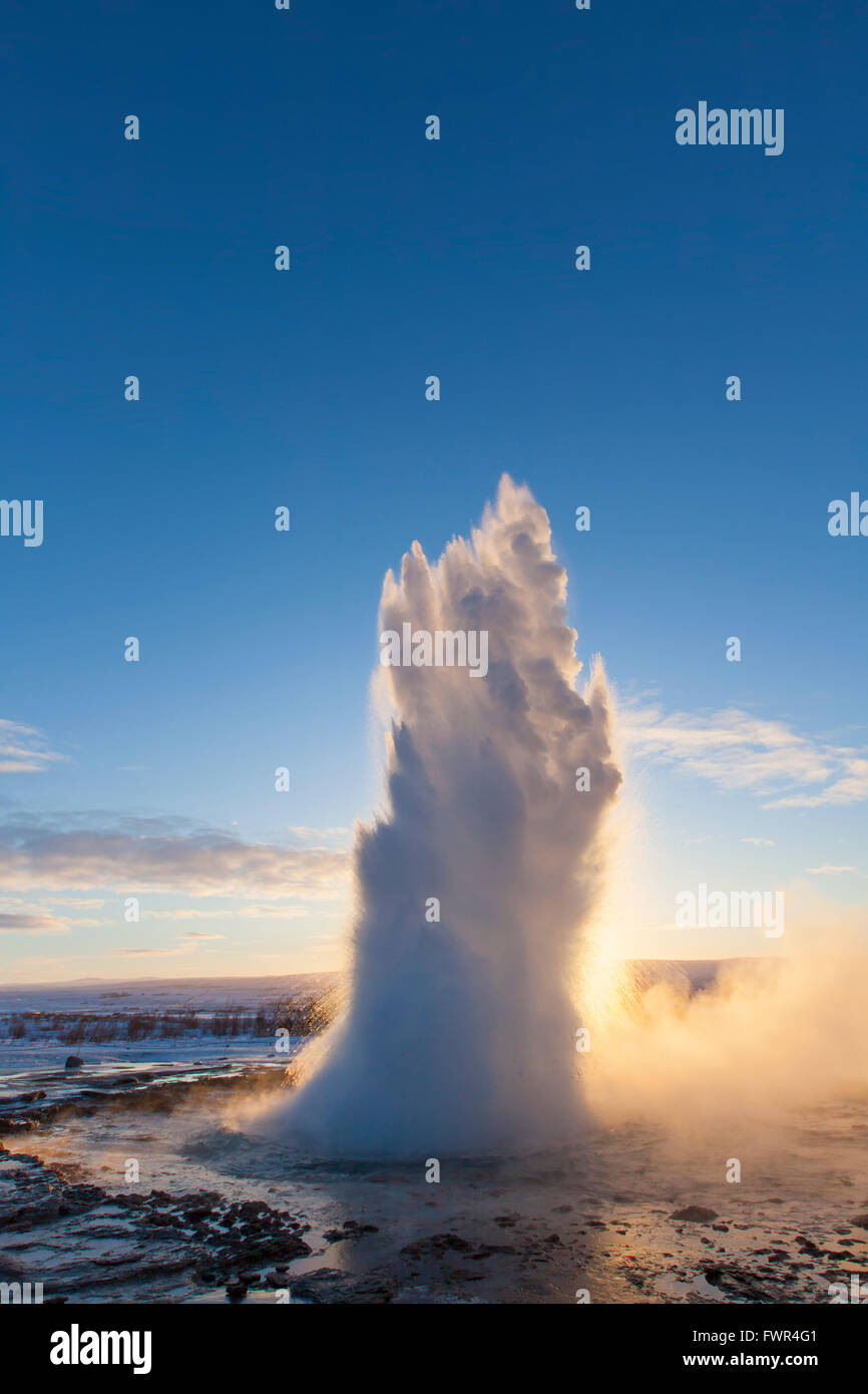 Eruption of Strokkur, fountain geyser in the geothermal area beside the ...