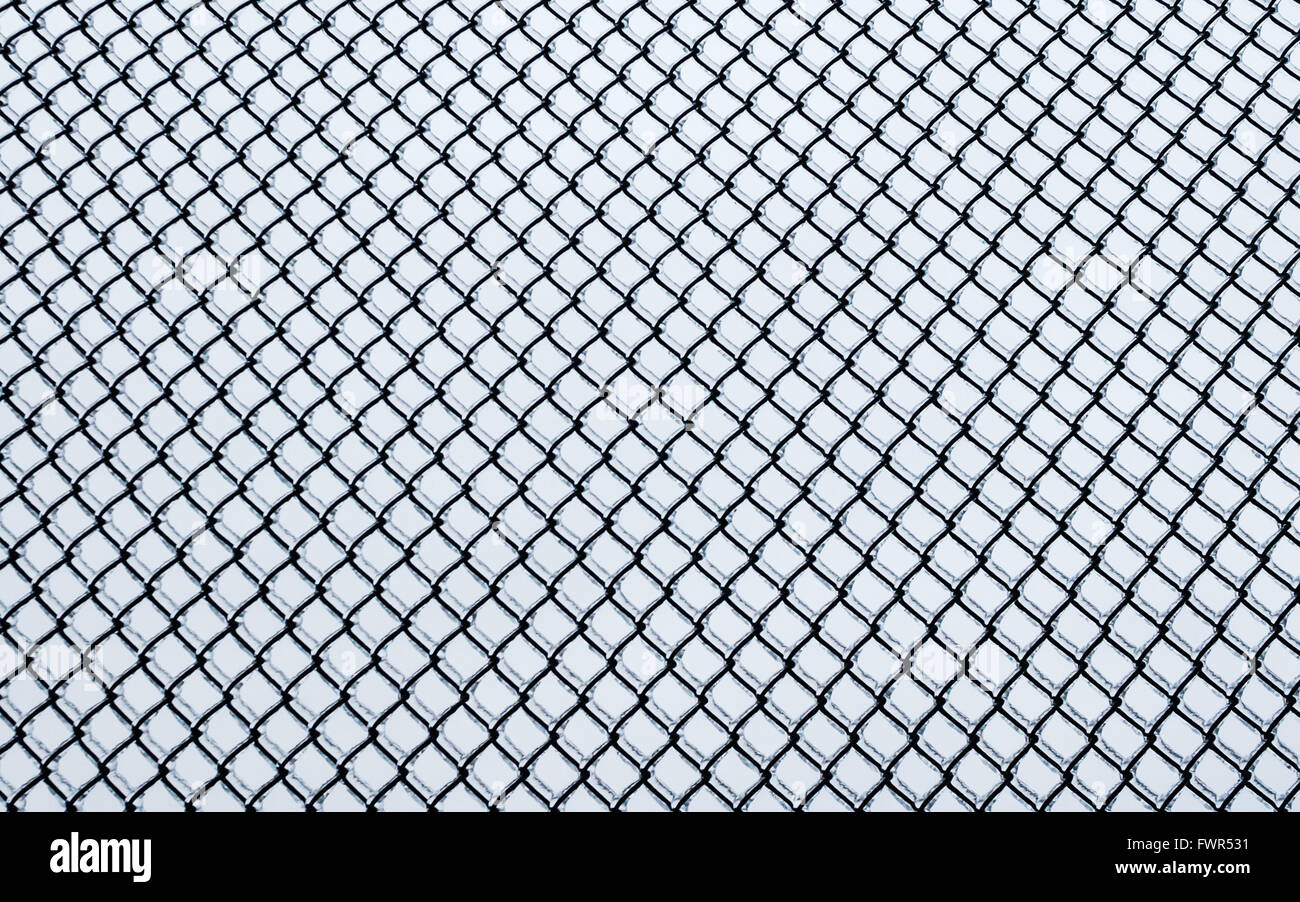 Black small chain-link fence covered in ice on white background Stock ...