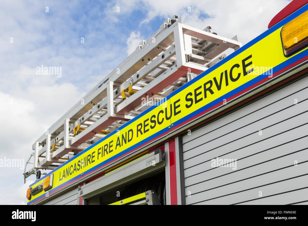 Lancashire Fire and Rescue legend on bright yellow backing on the side ...