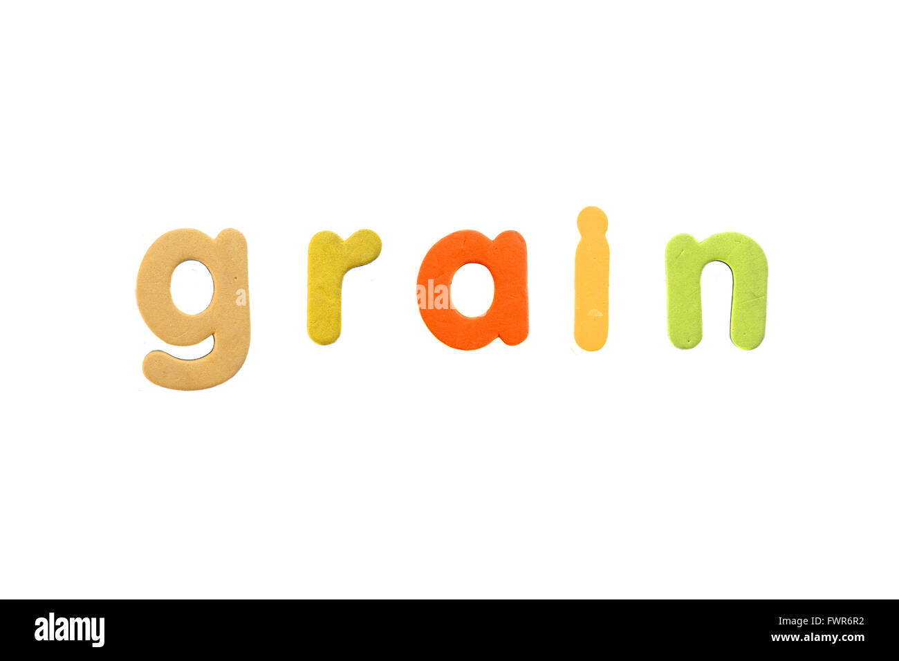 The word grain created from alphabetic fridge magnets against a white ...