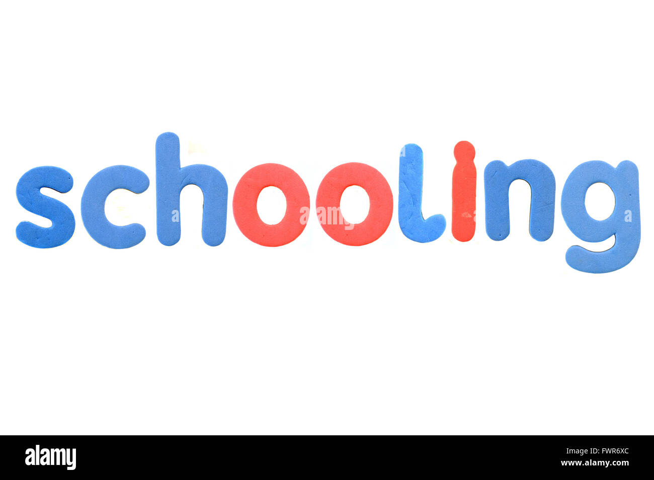 The word schooling created from alphabetic fridge magnets against a ...