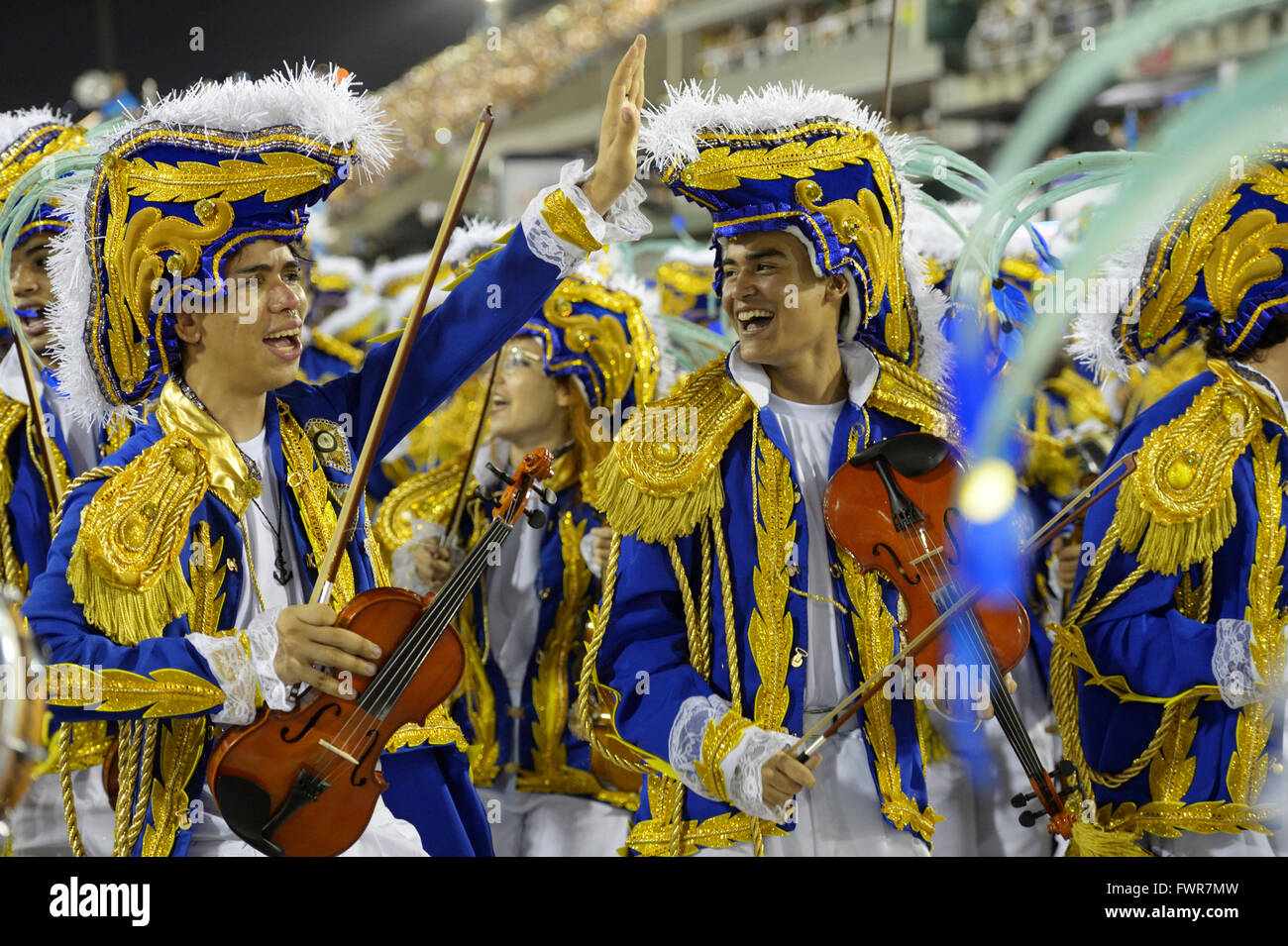 Teenagers in costumes with violins, Samba group Bateria, parade of the ...