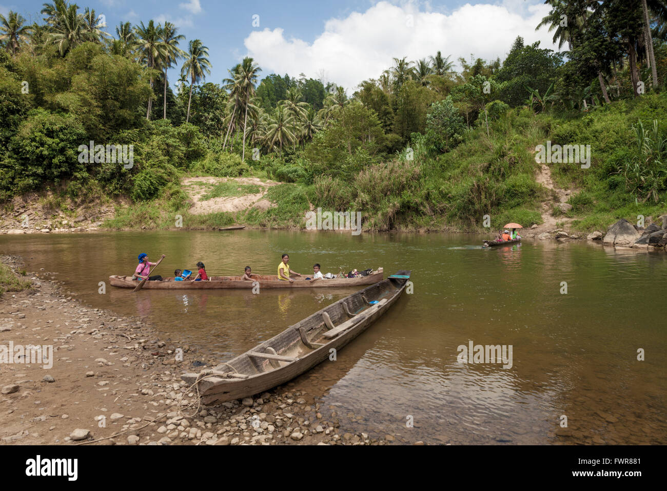 Traditional carved wood or timber boats on a river, northern Sabah ...