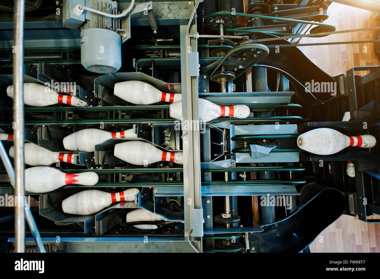 Pins on bowling pinsetter machine Stock Photo - Alamy