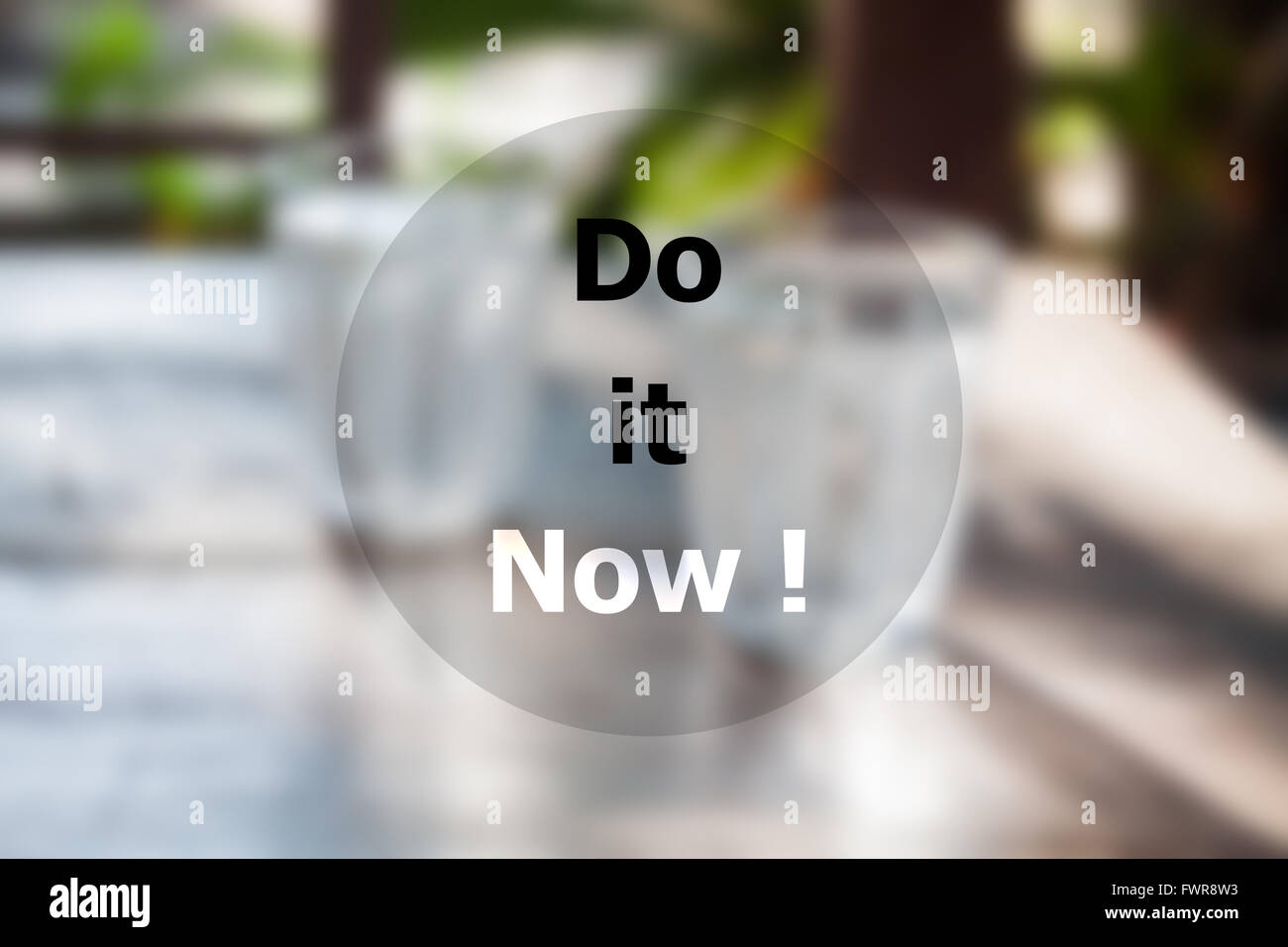 Do it now inspirational quote on blurred background Stock Photo - Alamy