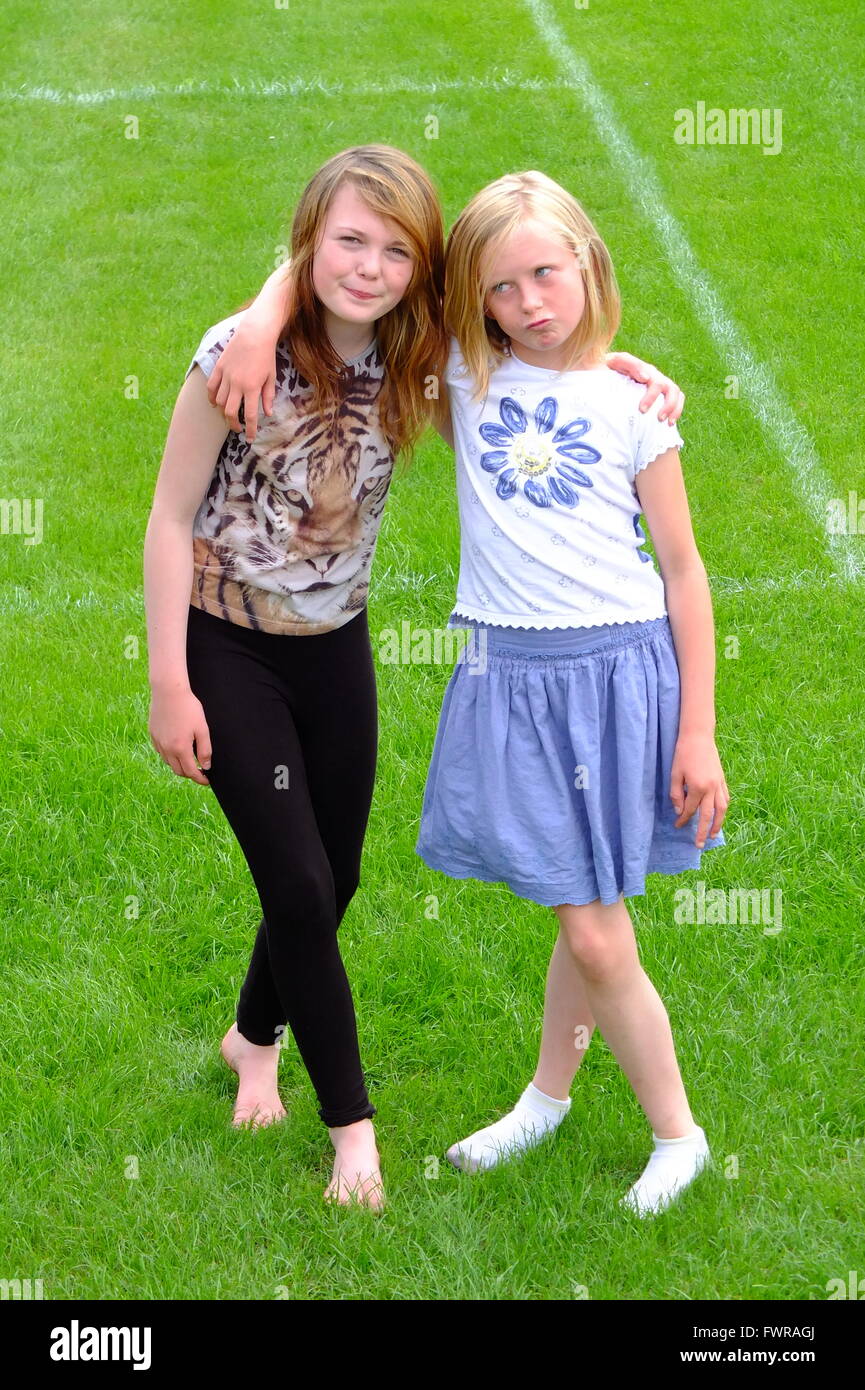 Two girls with arms around each other hi-res stock photography and ...