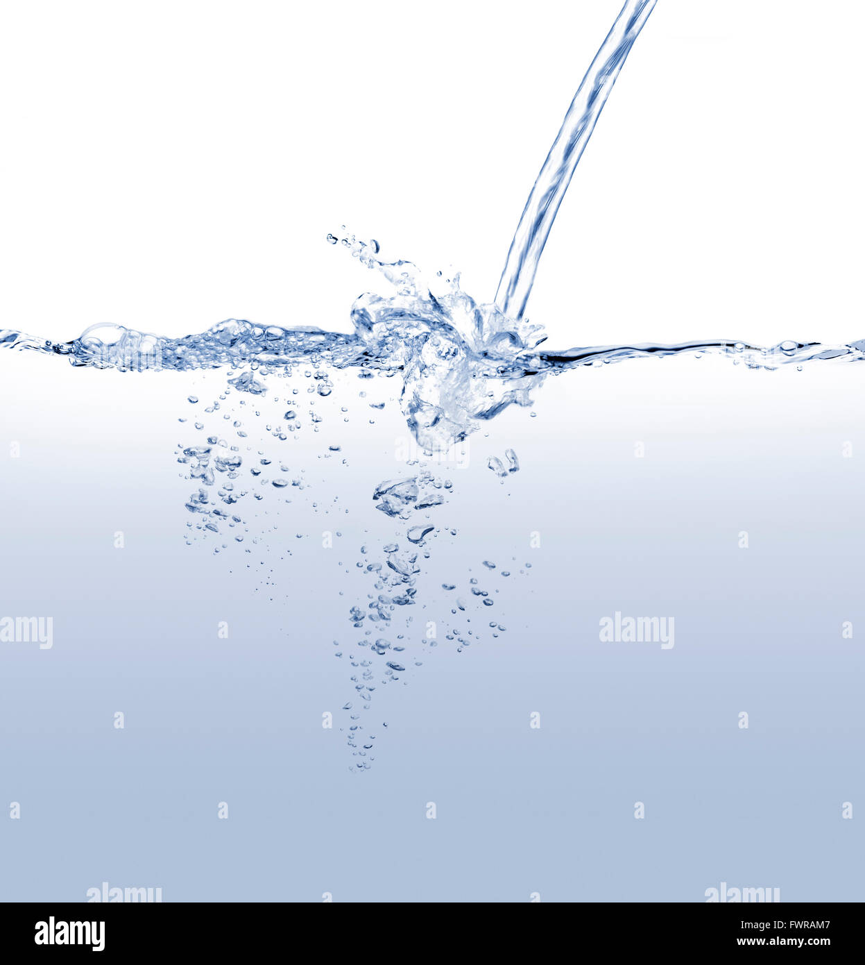 Water jet splashing against white background with a blue tone on water ...