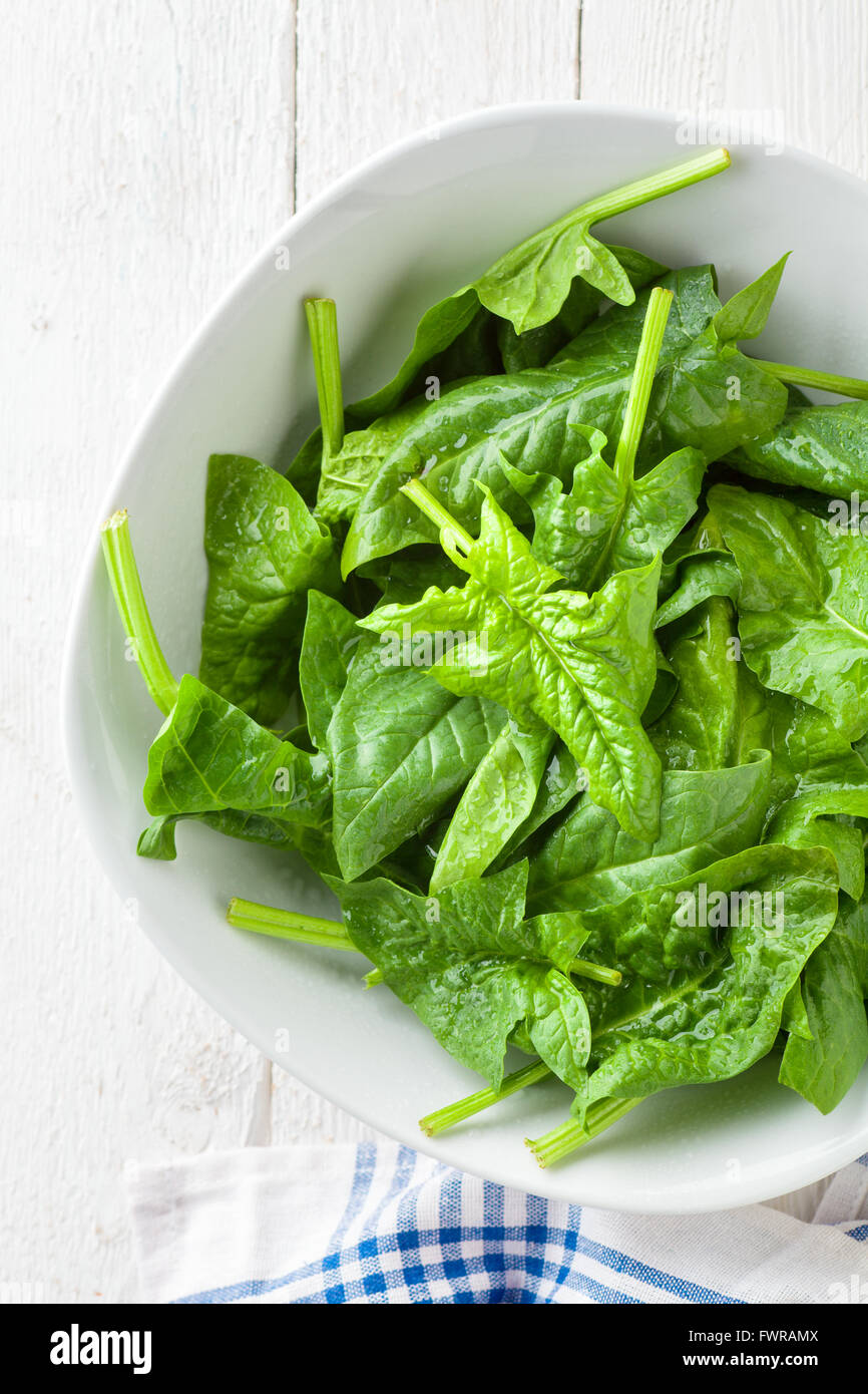Raw Spinach in a White Bowl on White Wood Stock Photo - Alamy