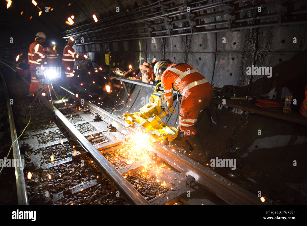 Engineers grinding replacement track components after using thermite ...