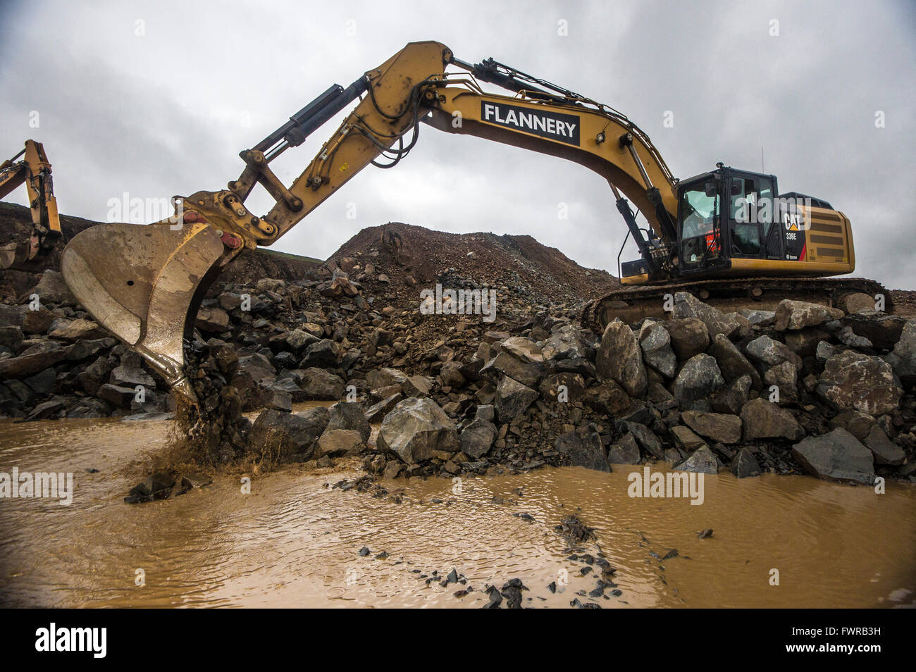 Diggers working during construction of Borders Railway, clearing rocks ...