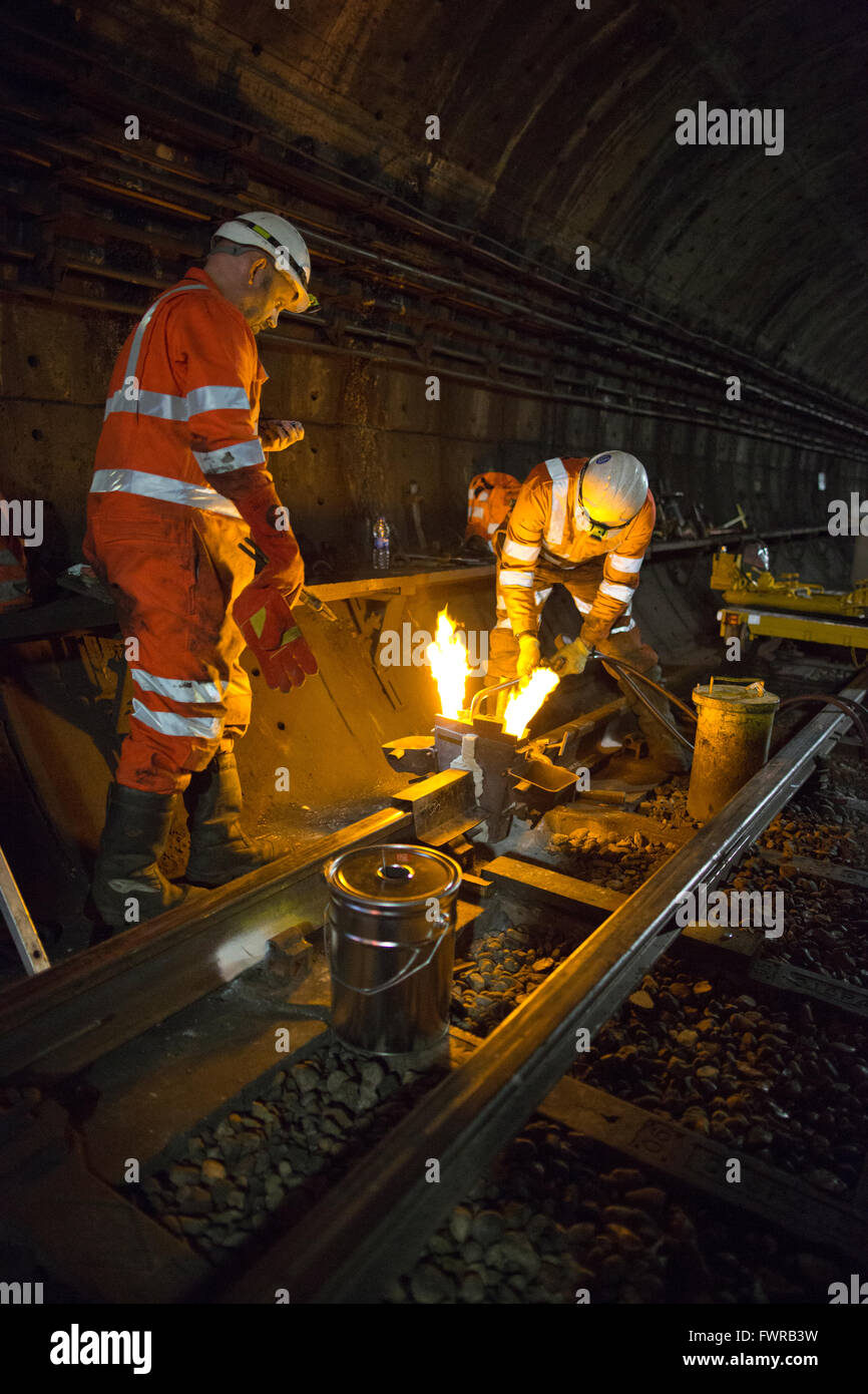 Engineers weld replacement track components together using thermite ...