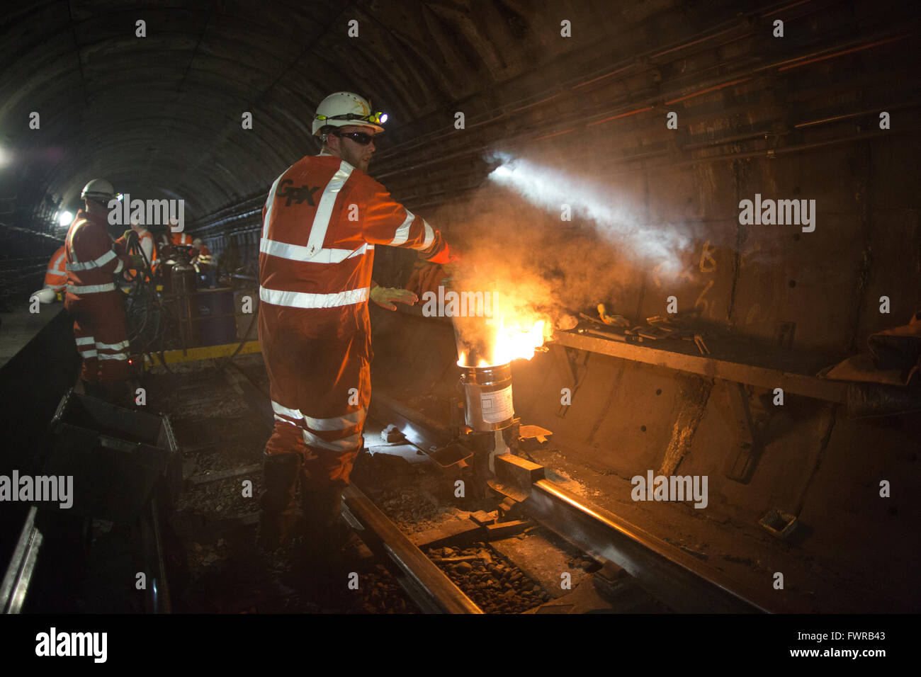 Engineers weld replacement track components together using thermite ...